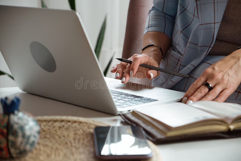 Unrecognizable Young Woman Making Notes in Notebook Sitting at ...