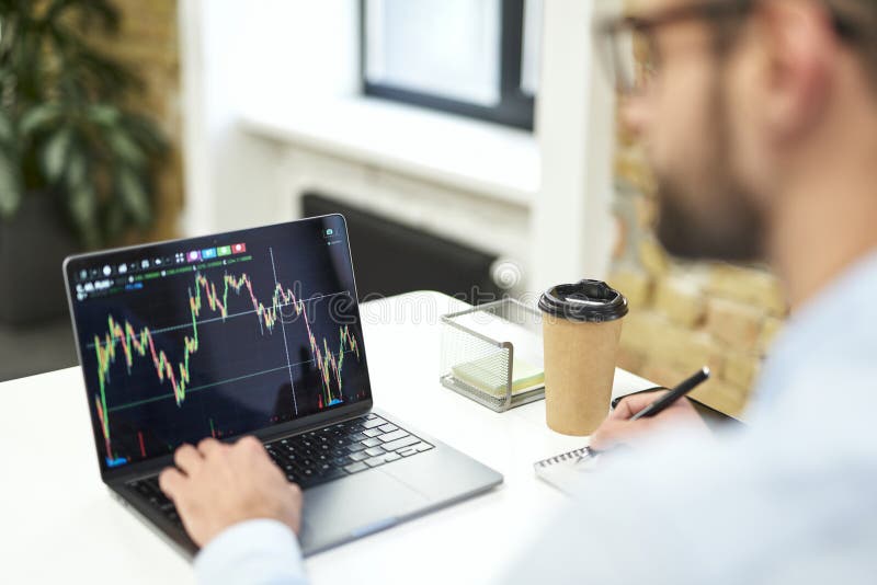 Unrecognized Office Worker Checking the Statistics in Computer Stock ...