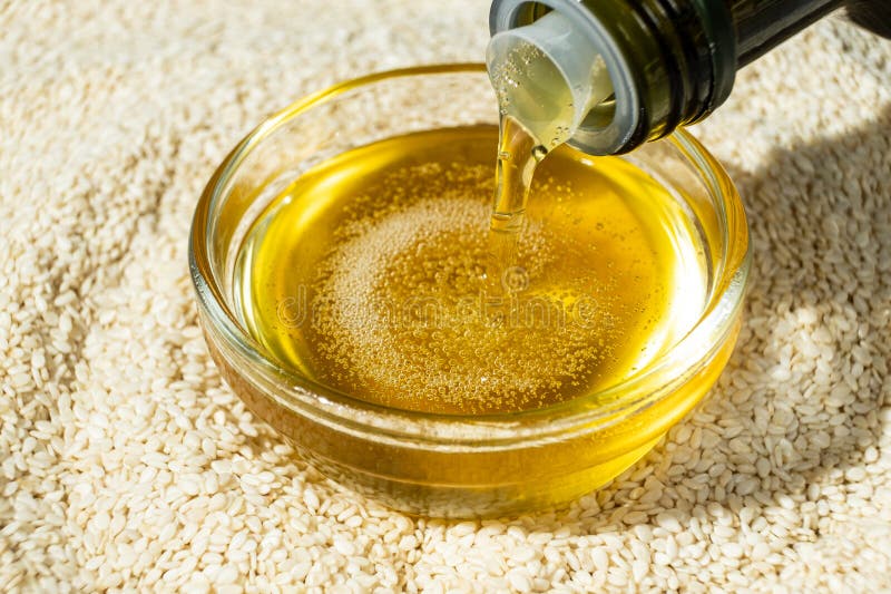 Unrefined Sesame Oil Pouring Out of Bottle Stock Photo - Image of brown ...