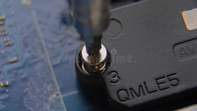 Unscrewing the Screw. a Hand Holding a Screwdriver is Installing or ...