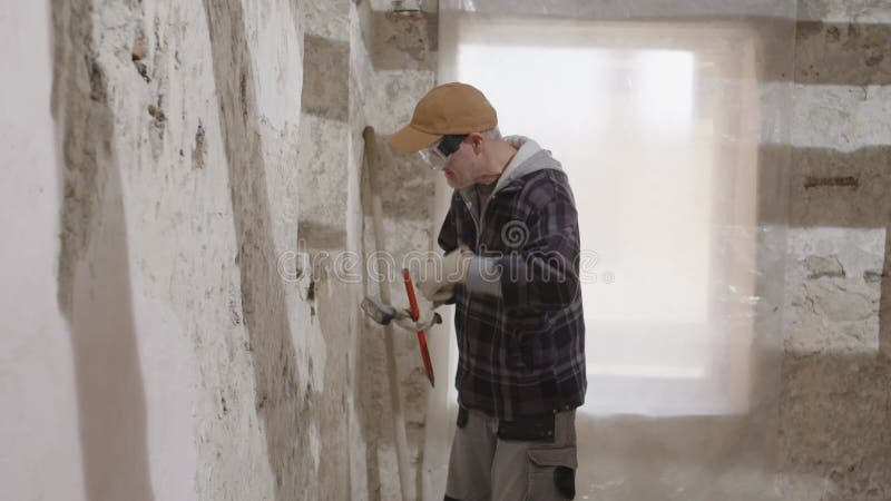 Unskilled Construction Worker at a Building Site Using Chisel and ...