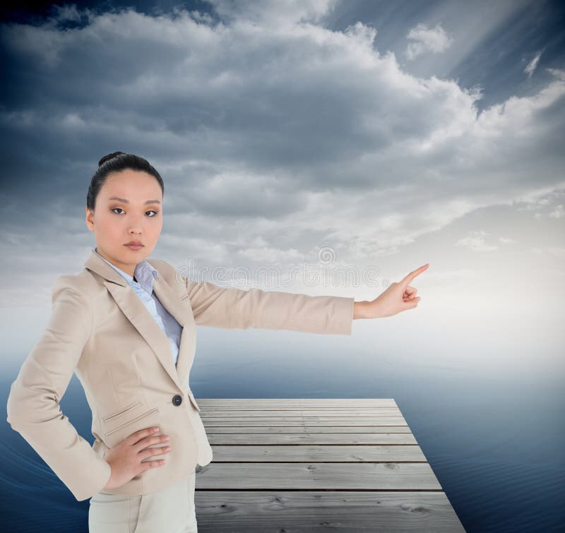 Unsmiling Asian Businesswoman Pointing Stock Photo - Image of water ...