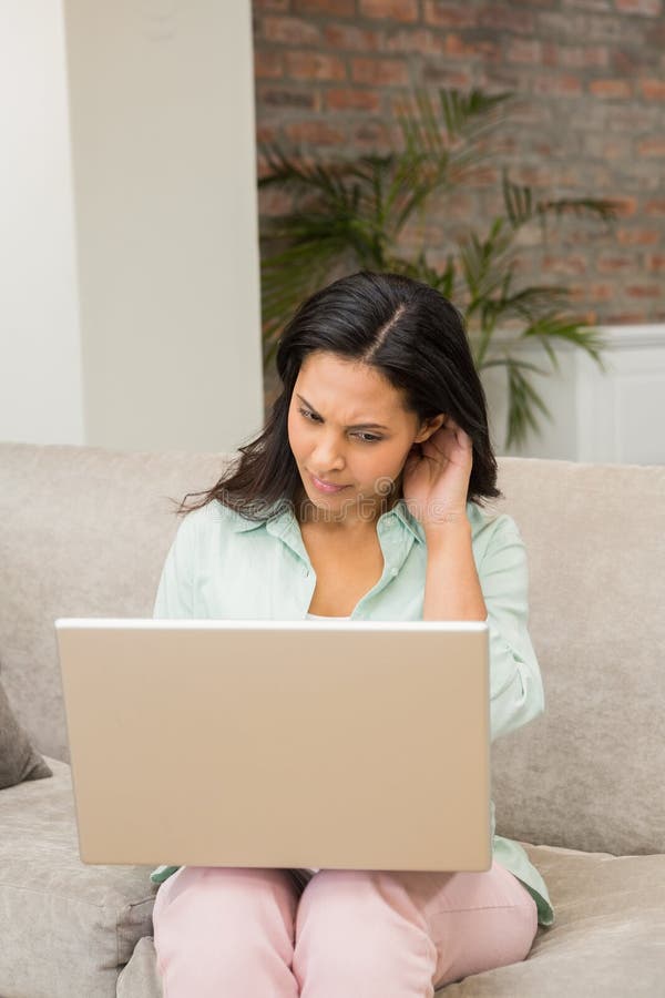 Unsmiling Brunette Using Laptop Stock Image - Image of brunette, hair ...