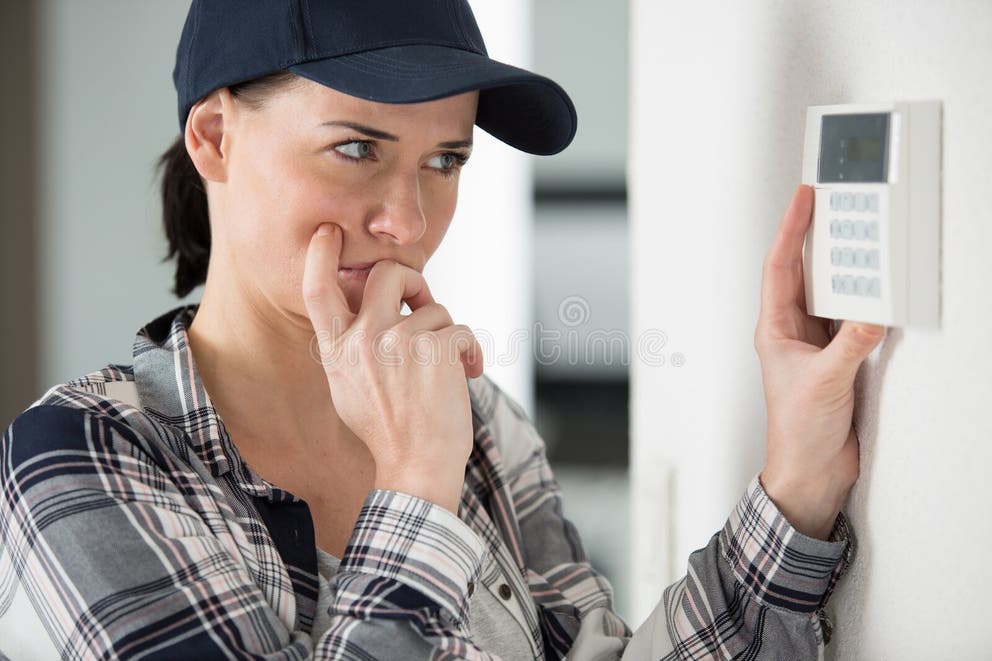 Unsure Female Worker Stood by Electronic Keypad Stock Photo - Image of ...