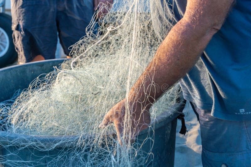 Mending a fishing net stock image. Image of fishermen - 160814651
