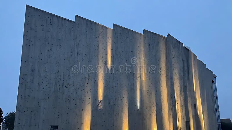 Sawtooth Serenity: Illuminated Concrete Facade at Twilight Stock ...