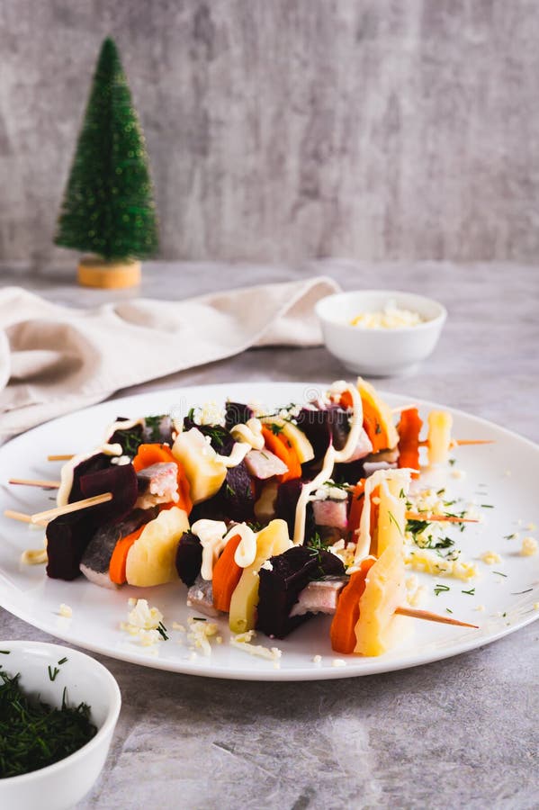 Unusual Herring Under a Fur Coat on Skewers on the Table Vertical View ...