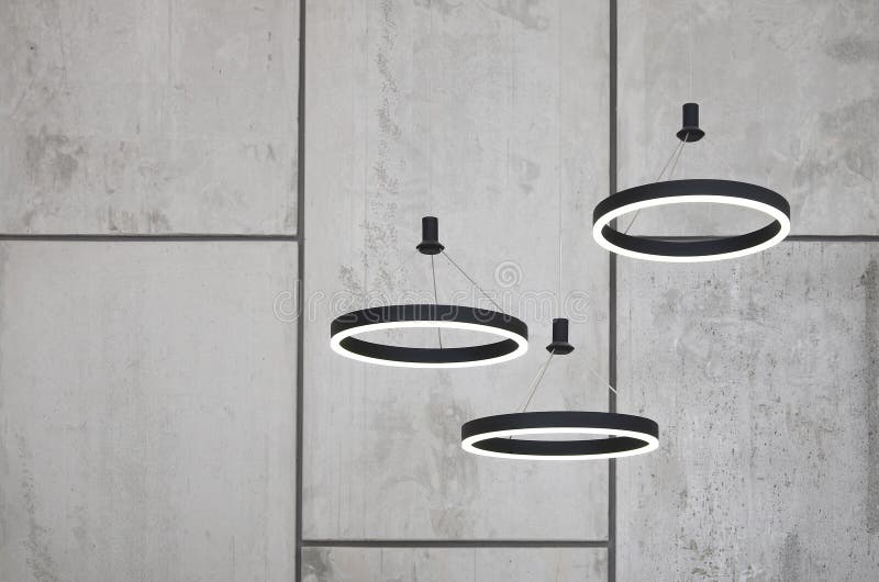 Unusual Light Sources Hang On The Background Of A Marble Wall. Lamps In ...