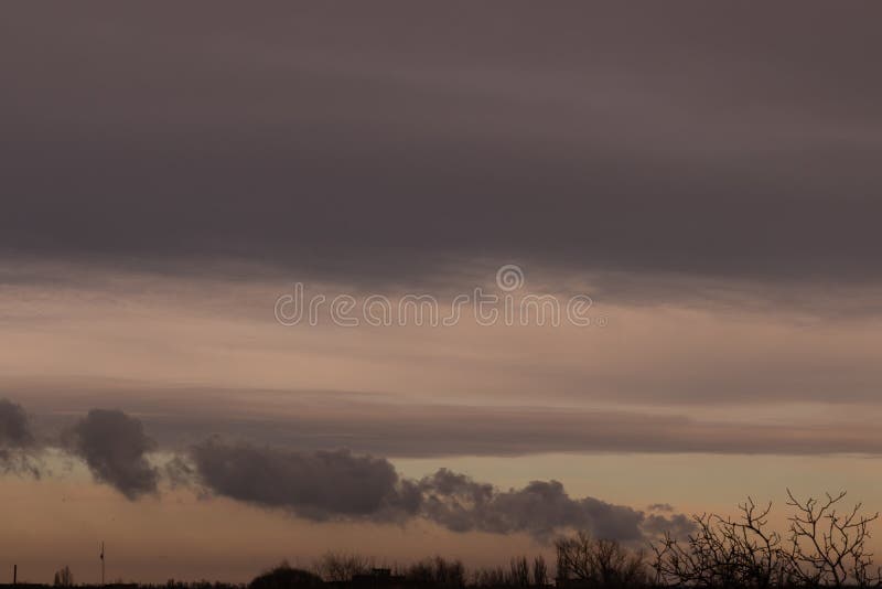 Unusual Rain Clouds of Different Colors at Sunset Over the Trees Stock ...