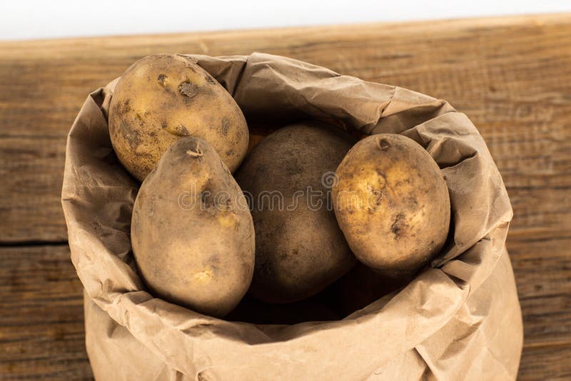 Unwashed Potatoes in a Paper Bag Islated on White Stock Image - Image ...