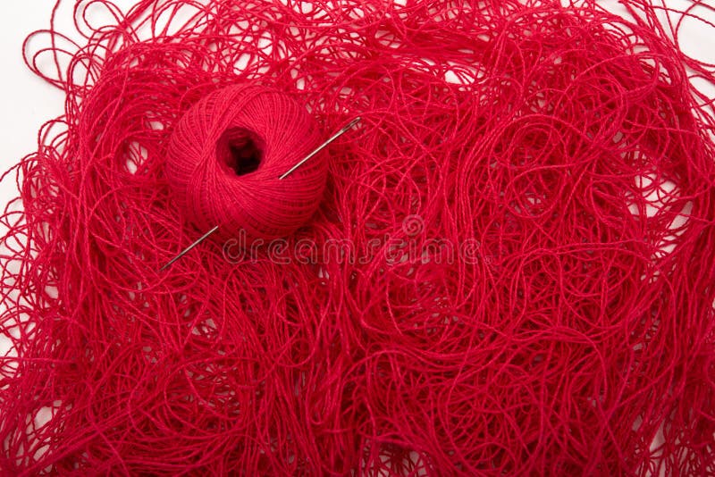 An Unwound Ball of Thread, the Thread Forms a Heart on a White ...