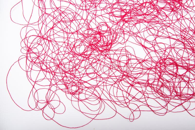 An Unwound Ball of Thread, the Thread Forms a Heart on a White ...