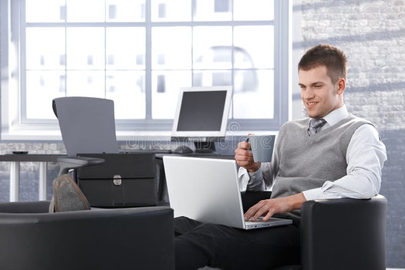 Imprenditore Sorridente Che Lavora Al Laptop in Ufficio Immagine Stock ...