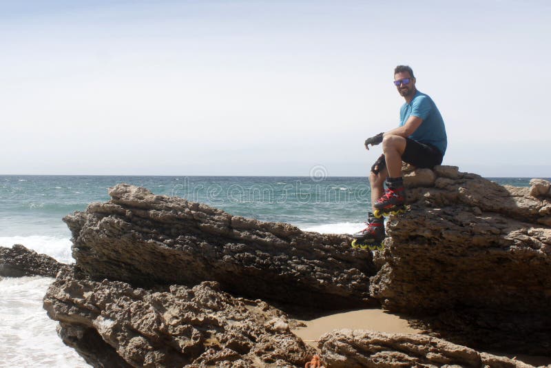 Uomo Su Una Roccia Alla Spiaggia Immagine Stock - Immagine di pace ...