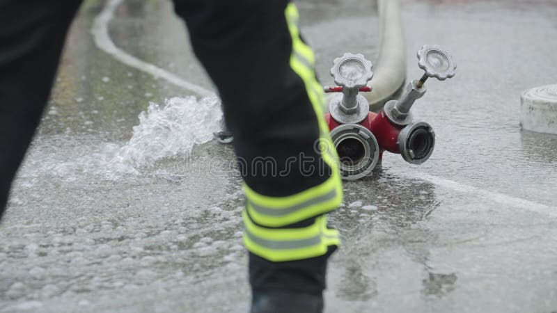 An Up-close Shot Captures a Fire Hose with a Powerful Stream of Water ...