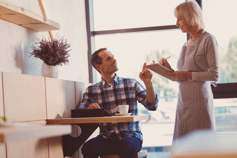 Upbeat Young Man Asking Waitress about Menu Stock Photo - Image of ...