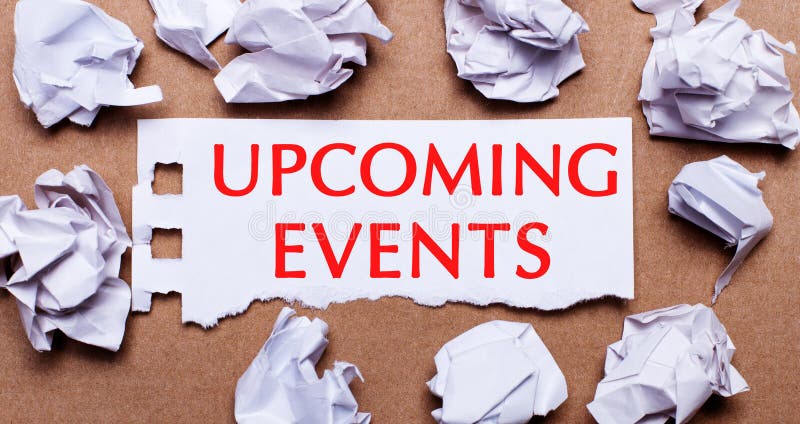 UPCOMING EVENTS Written on White Paper on a Light Brown Background ...