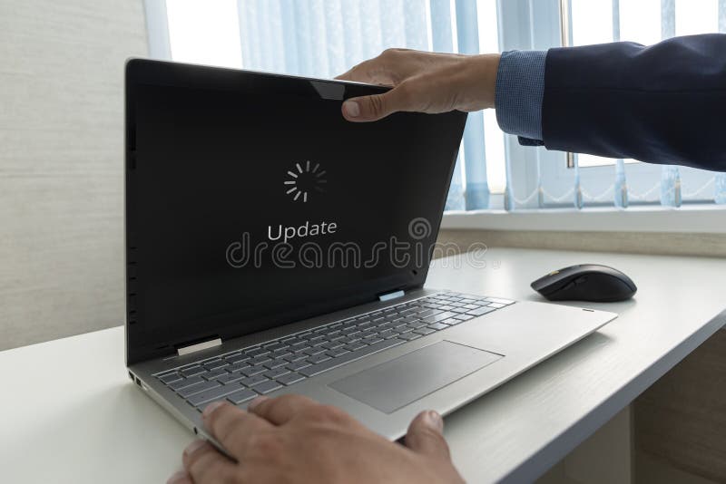 Businessman Opens a Modern Ultrabook on Which the Operating System is ...