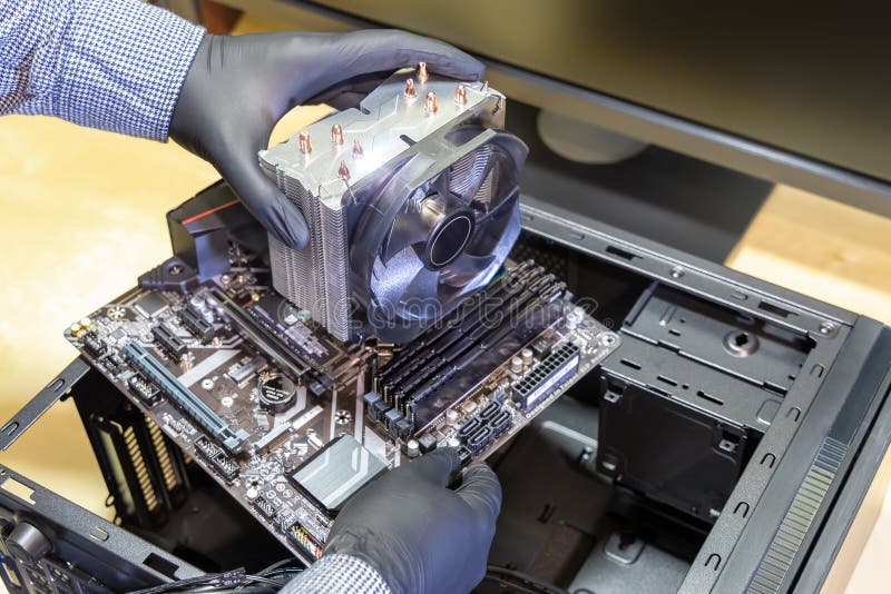Upgrade or PC Assembly Concept. Technician Installs a New Motherboard ...