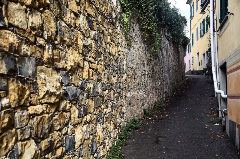 Uphill Alley between a Stone Wall and a Building Stock Photo - Image of ...