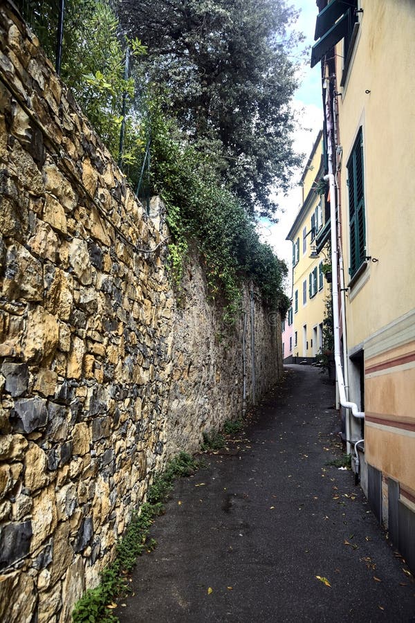 Uphill Alley between a Stone Wall and a Building Stock Photo - Image of ...