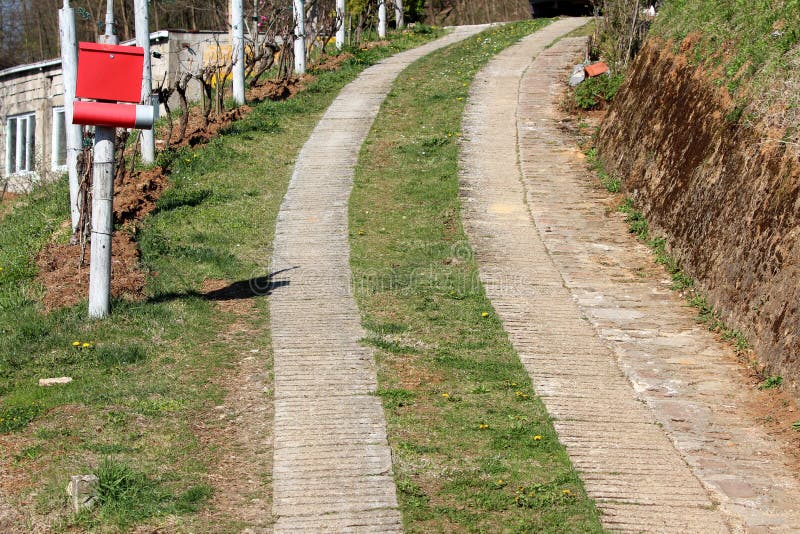 Uphill Path in Rural Area Made of Stone Tiles and Grass Surrounded with ...