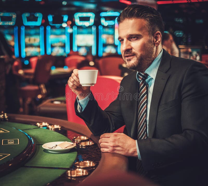 Upper Class Man Behind Gambling Table in a Casino Stock Photo - Image ...