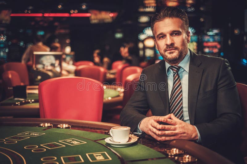 Upper Class Man Behind Gambling Table in a Casino Stock Photo - Image ...