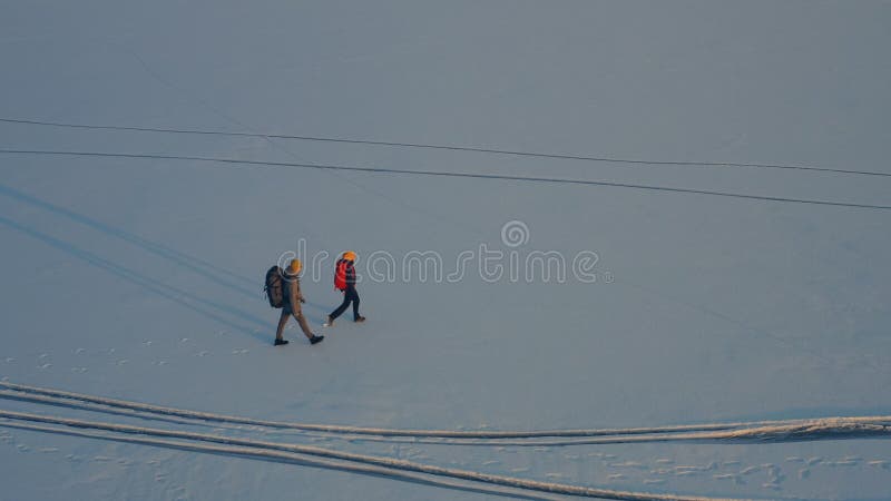 The Upper View on Two Tourists Trekking through the Icy Field. Stock ...