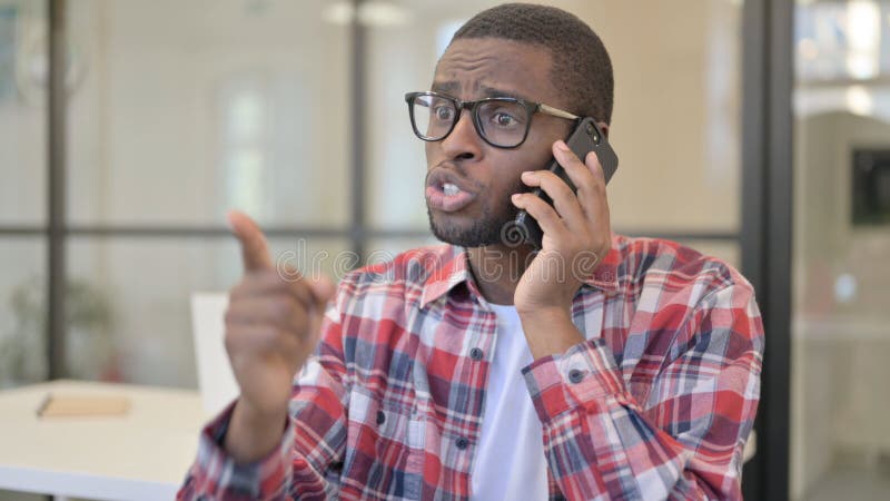 Upset African Man Talking Angrily on Smartphone Stock Photo - Image of ...
