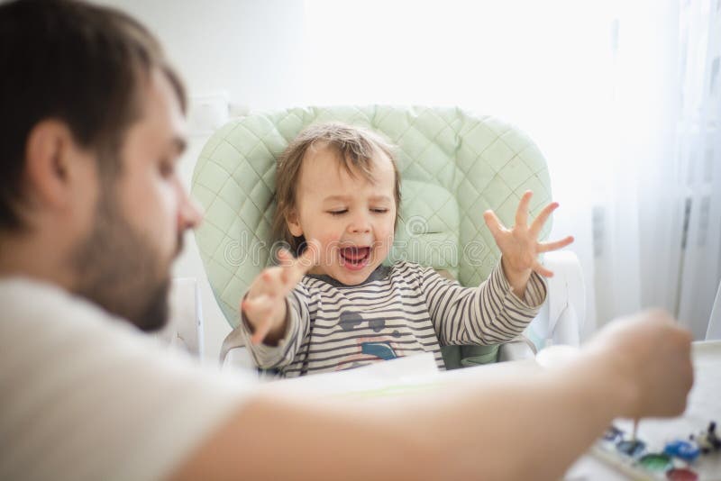 Upset and Angry Little Boy with Dad Sitting at the Table and Painting ...