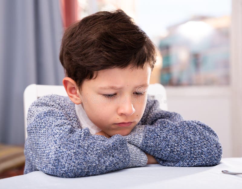 Upset Boy Sitting at Table and Thinks about Problems Stock Image ...