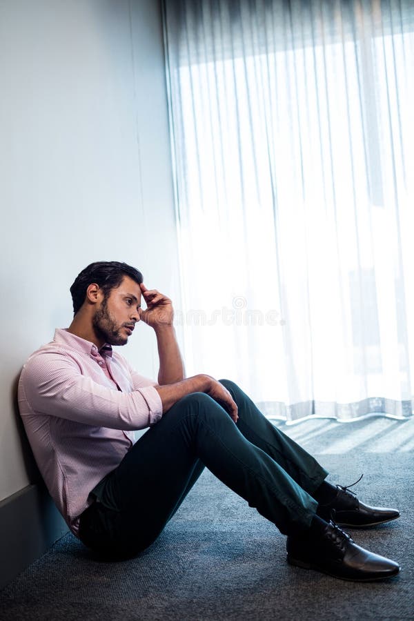 Upset Businessman Sitting Against the Wall Stock Image - Image of ...