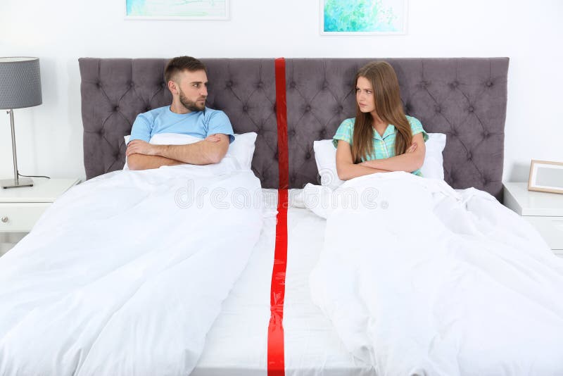 Upset Couple with Relationship Problems Lying Separately Stock Image ...