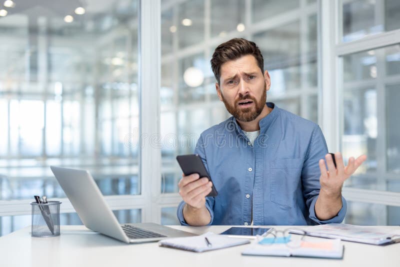 Upset and Disappointed Man with Phone in Hands. Office Worker at ...