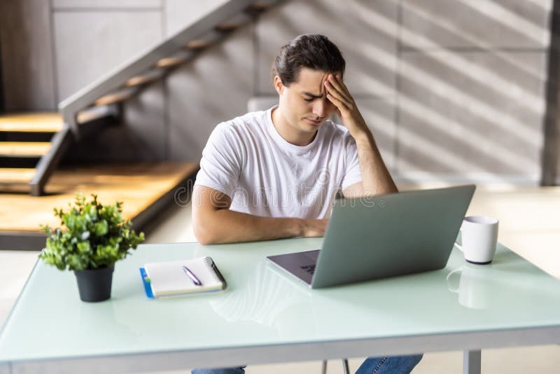 Upset Discouraged Young Man Looking with Disappointment on Laptop while ...