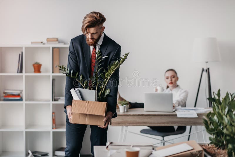 Upset Fired Businessman with Cardboard Box in Office, Boss Behind Stock ...