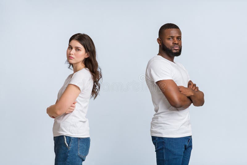 Upset Interracial Couple Standing Back To Back with Folded Arms Stock ...
