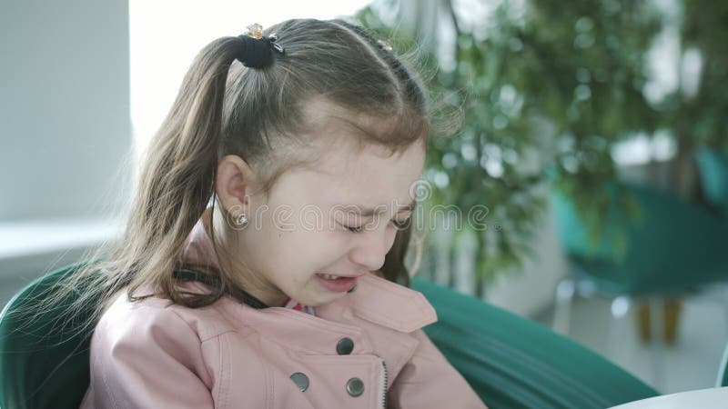 Upset Little Girl Crying in a Cafe by the Window. Stock Footage - Video ...