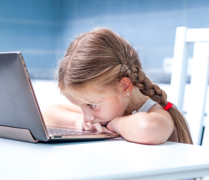 Upset Little Girl with Her Computer Stock Photo - Image of book ...
