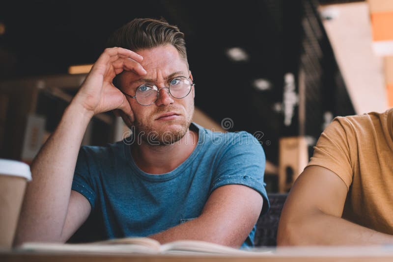 Upset Male Students Working on Diploma Project in Cafe Stock Photo ...