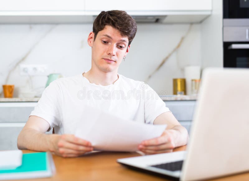 Upset Man with Laptop and Utility Bills in Kitchen Stock Image - Image ...