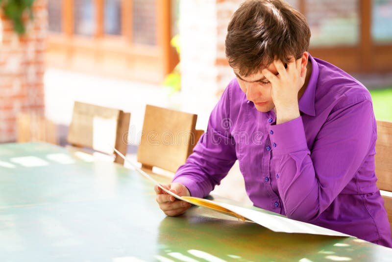 Upset Man Looking in the Menu Stock Photo - Image of alone, happy: 31407778