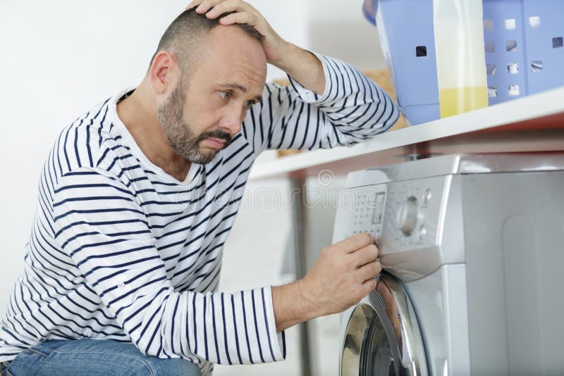 Upset Man Sitting Next To Washing Machine Stock Image - Image of load ...