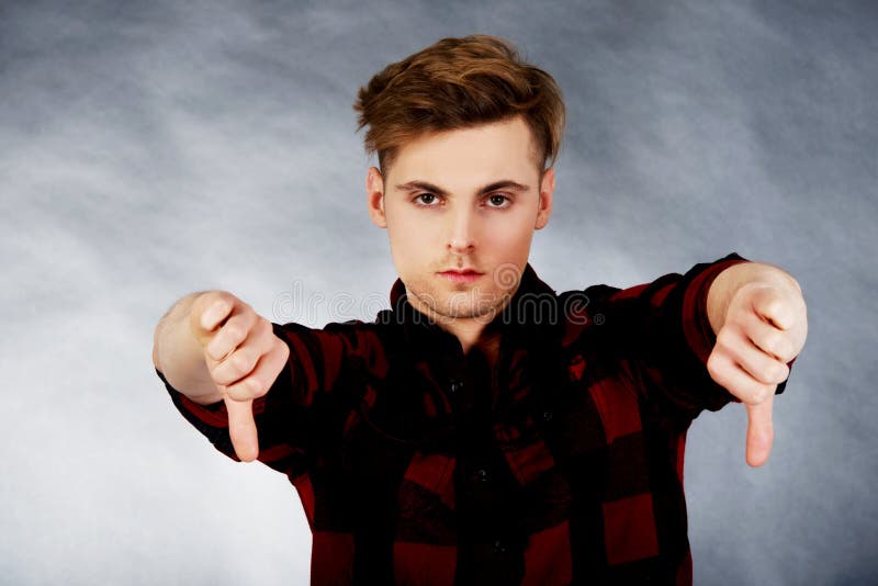 Upset Man with Thumbs Down. Stock Photo - Image of student, male: 58889098