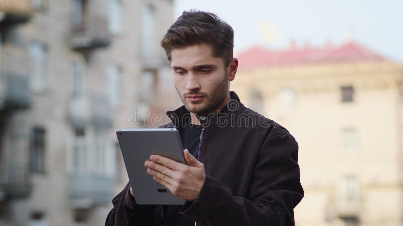 Upset Man Using Tablet Outside. Serious Guy Looking Screen Outdoors ...