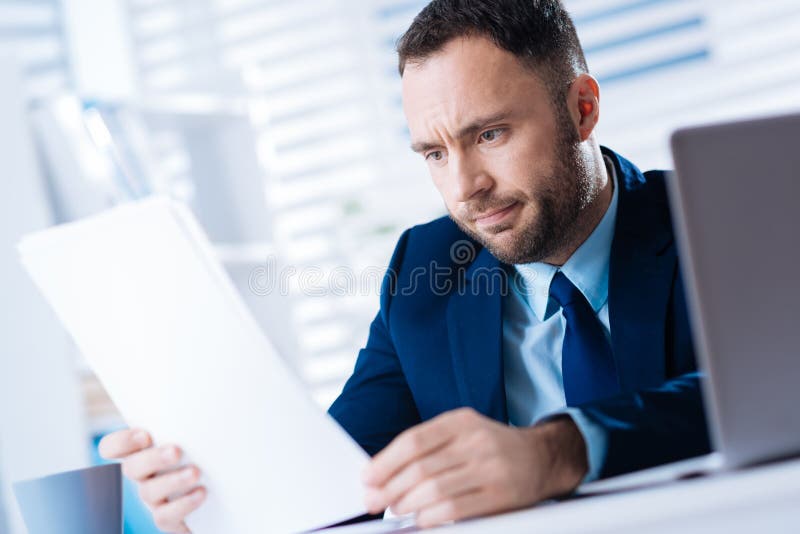 Upset Manager Looking Unhappy while Reading the Documents Stock Photo ...