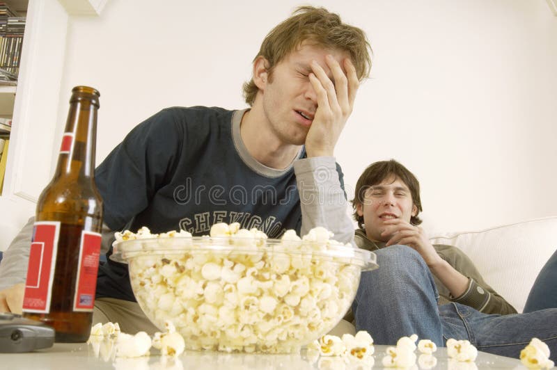 Upset Men Watching TV with Popcorn and Beer on Table Stock Image ...