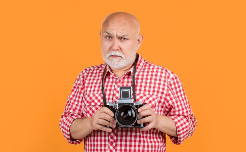 Upset Old Man with Retro Photo Camera on Yellow Baqckground Stock Photo ...