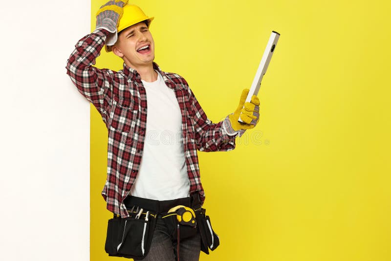 Smiling Professional Builder in Work Clothes in Helmet with Level ...